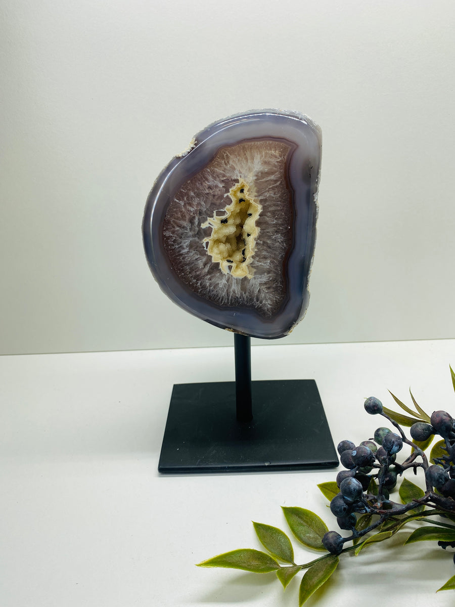 Large Natural Agate Geode with Quartz crystals inside on black stand ...